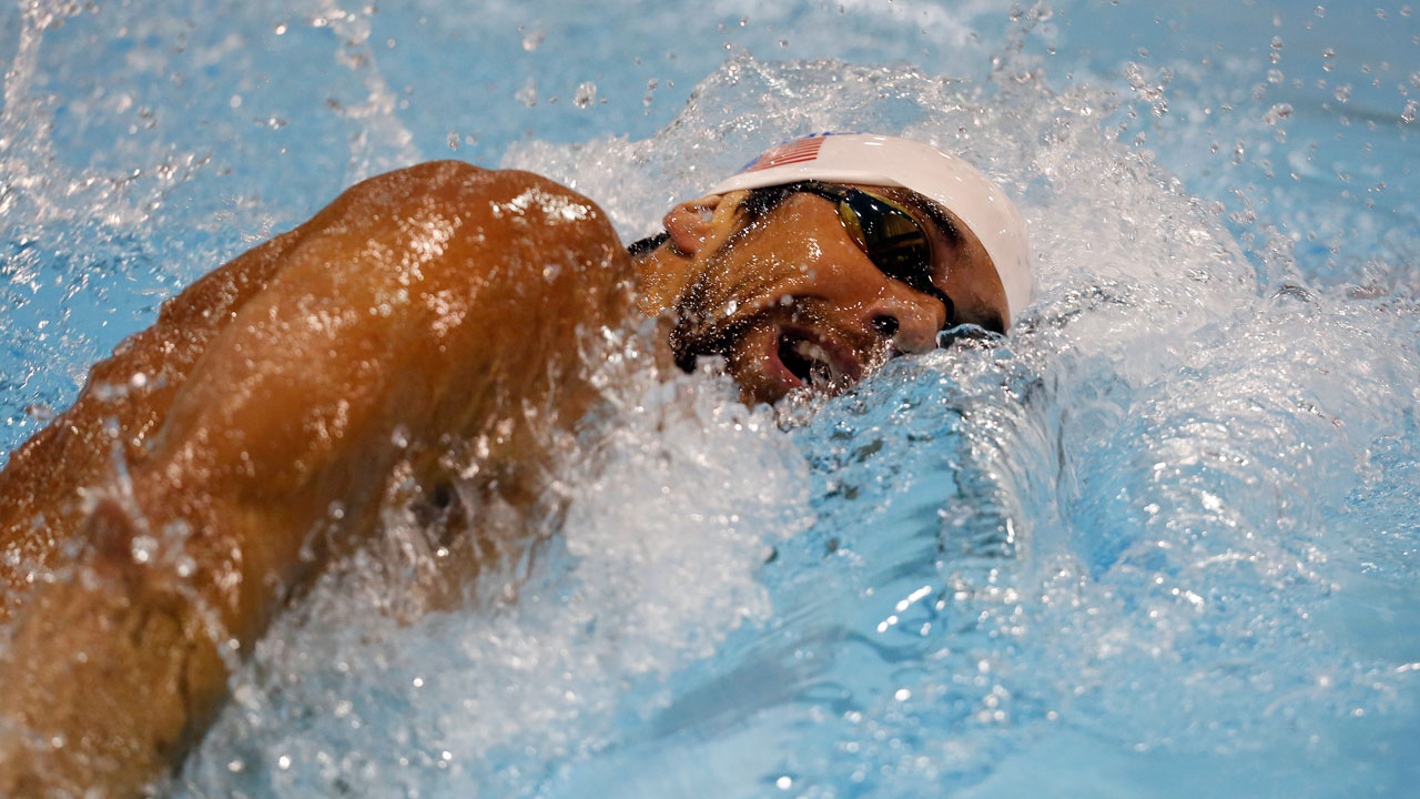 Phelps races to first win since London