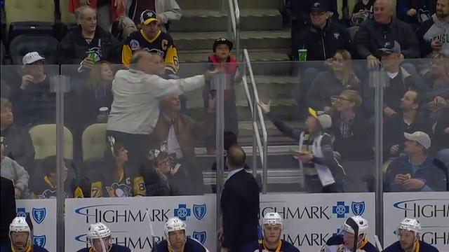Adult Pittsburgh fan intercepts puck from little kid in crowd