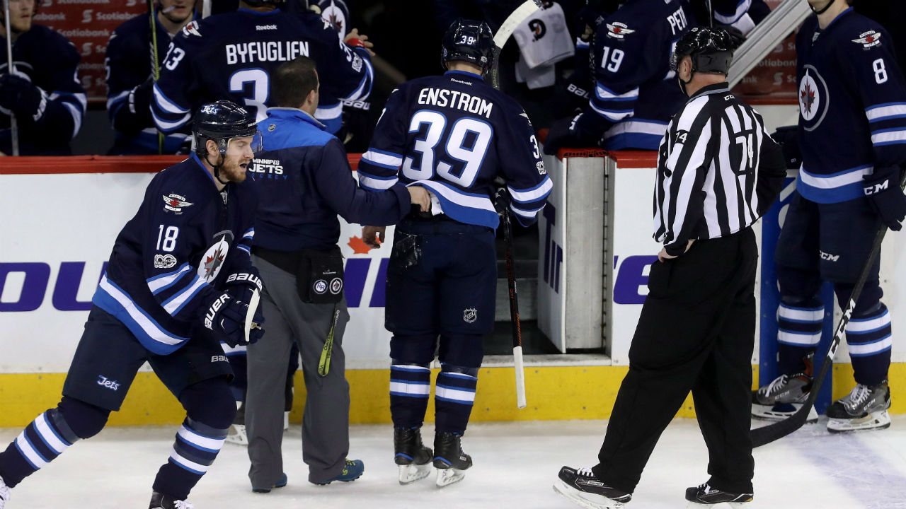 Toby Enstrom leaves game after hard crash into boards