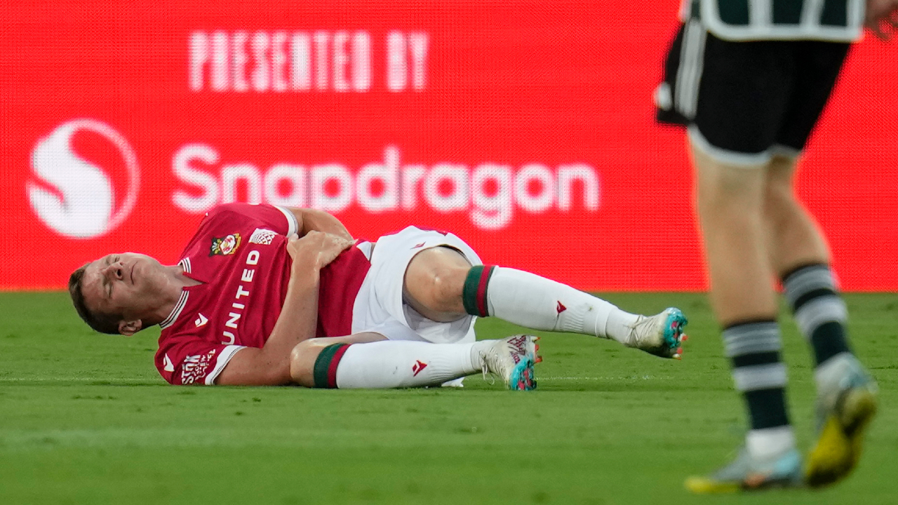 Wrexham striker Paul Mullin injured in collision with Manchester United ...