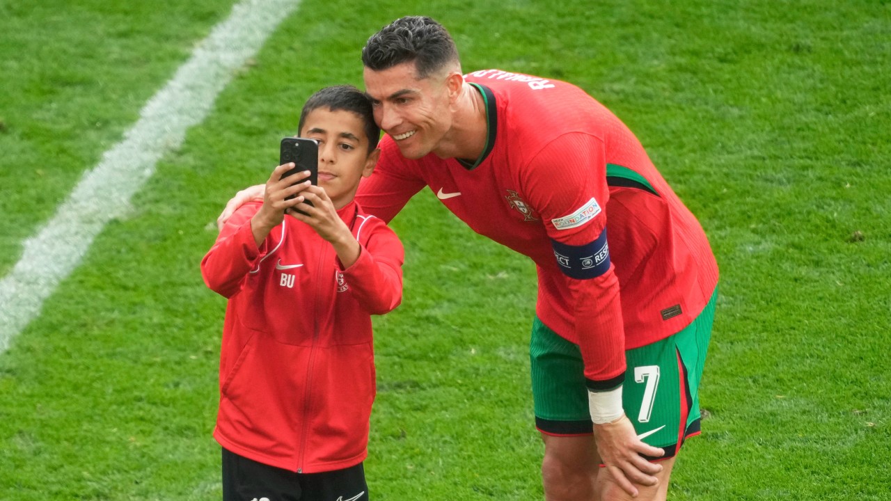 Four fans get on field for selfies with Ronaldo during match at Euro ...